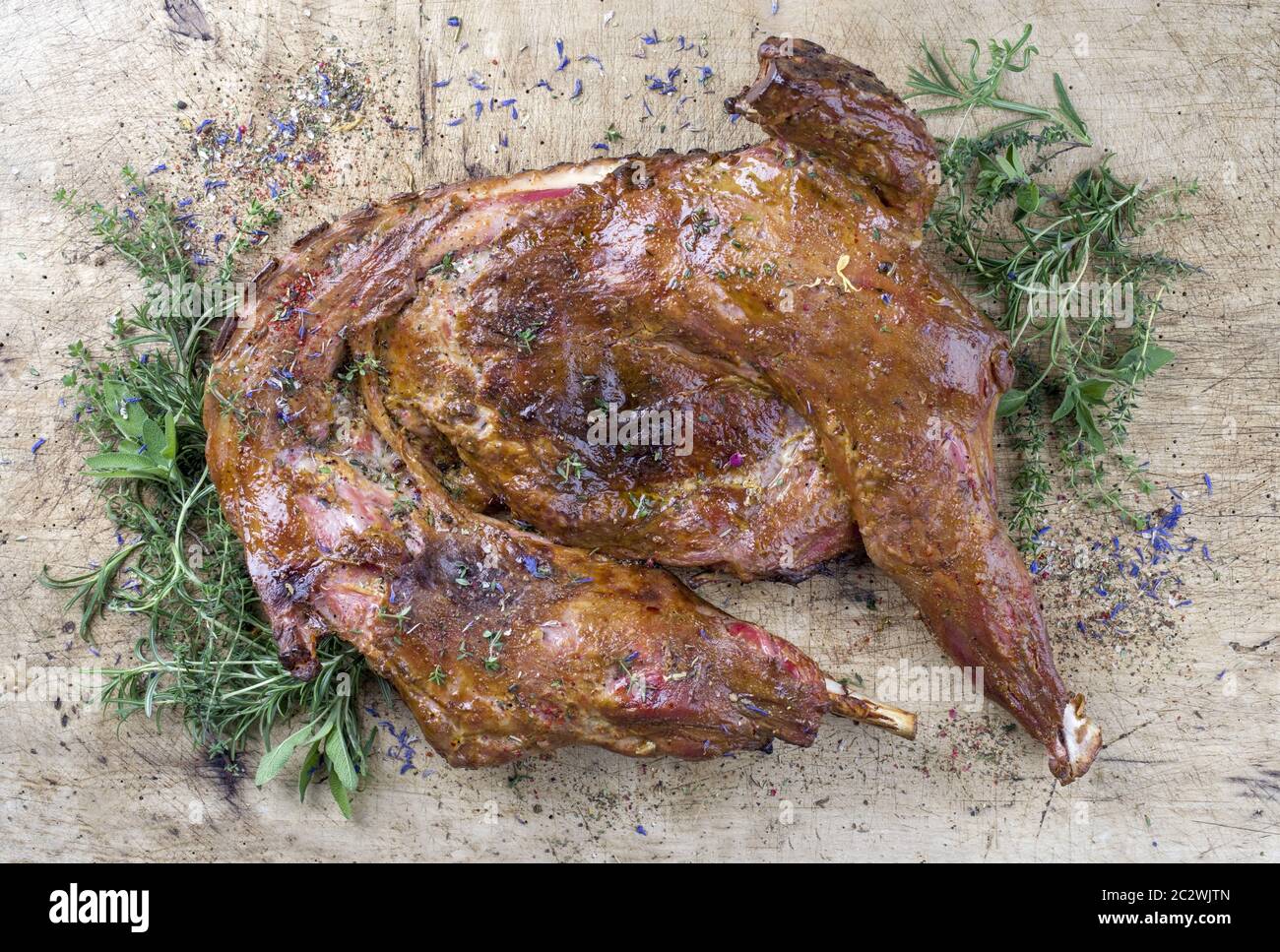 Barbecue half of dairy goat with shoulder and leg garnished with a ...