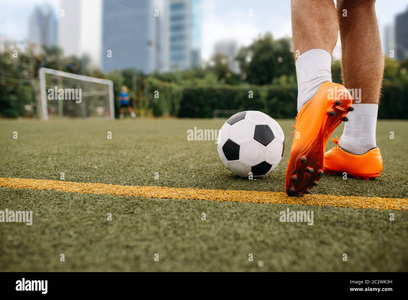 Male soccer player working with ball on the field. Footballer on ...