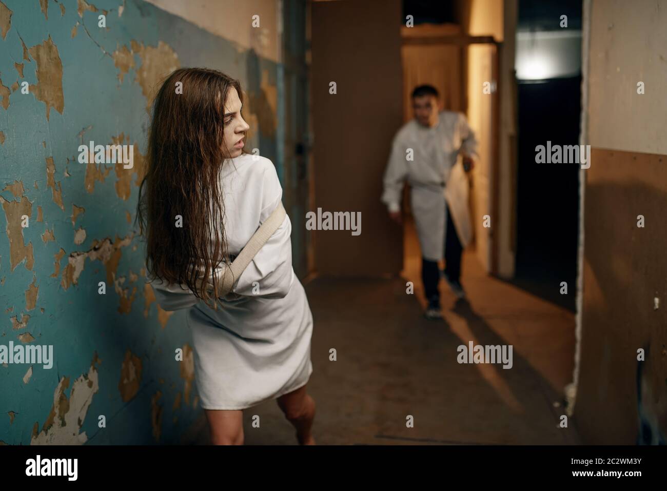 Crazy female patient in straitjacket runs away from the psychiatrist ...