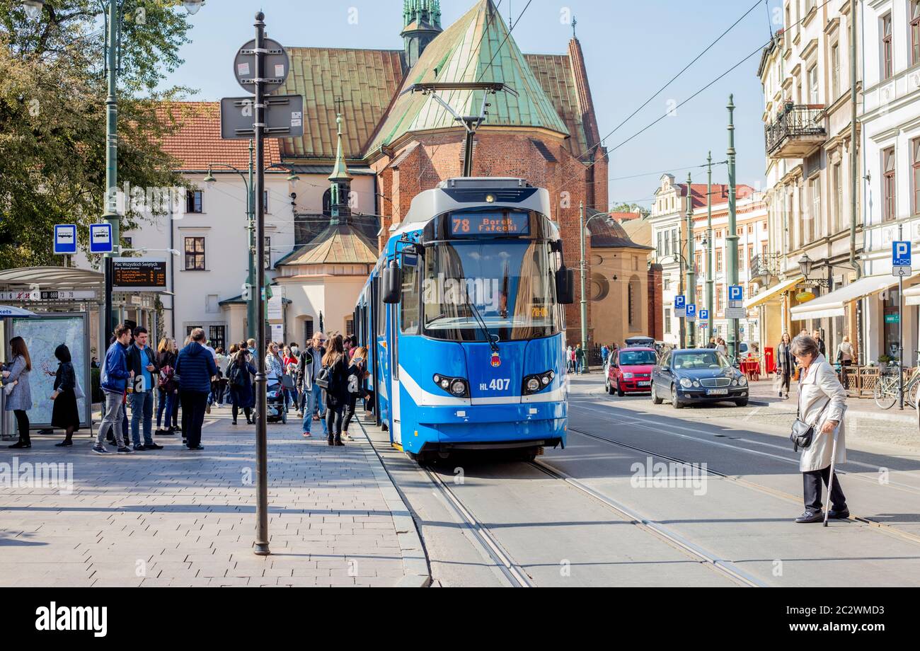 Busy street scene and tram stop and tram in Krakow. Poland Stock Photo ...