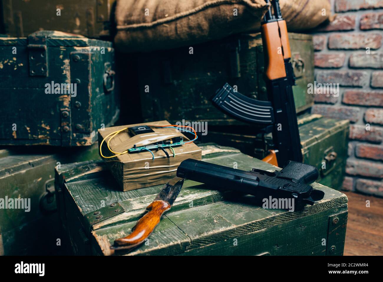 Bomb, knife, gun and kalashnikov rifle on box of ammunition, nobody ...