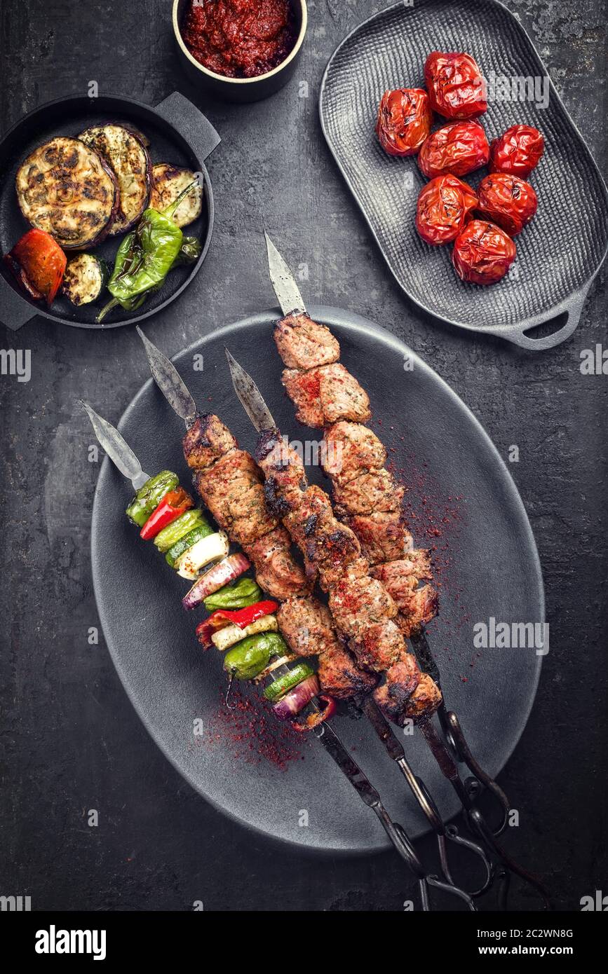 Traditional Russian shashlik on a barbecue skewer with vegetable and ...