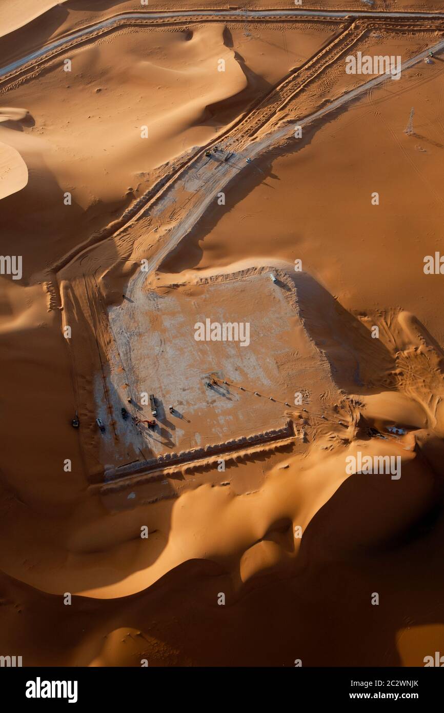 A capped off oil well in the Sahara desert awating connection to a ...