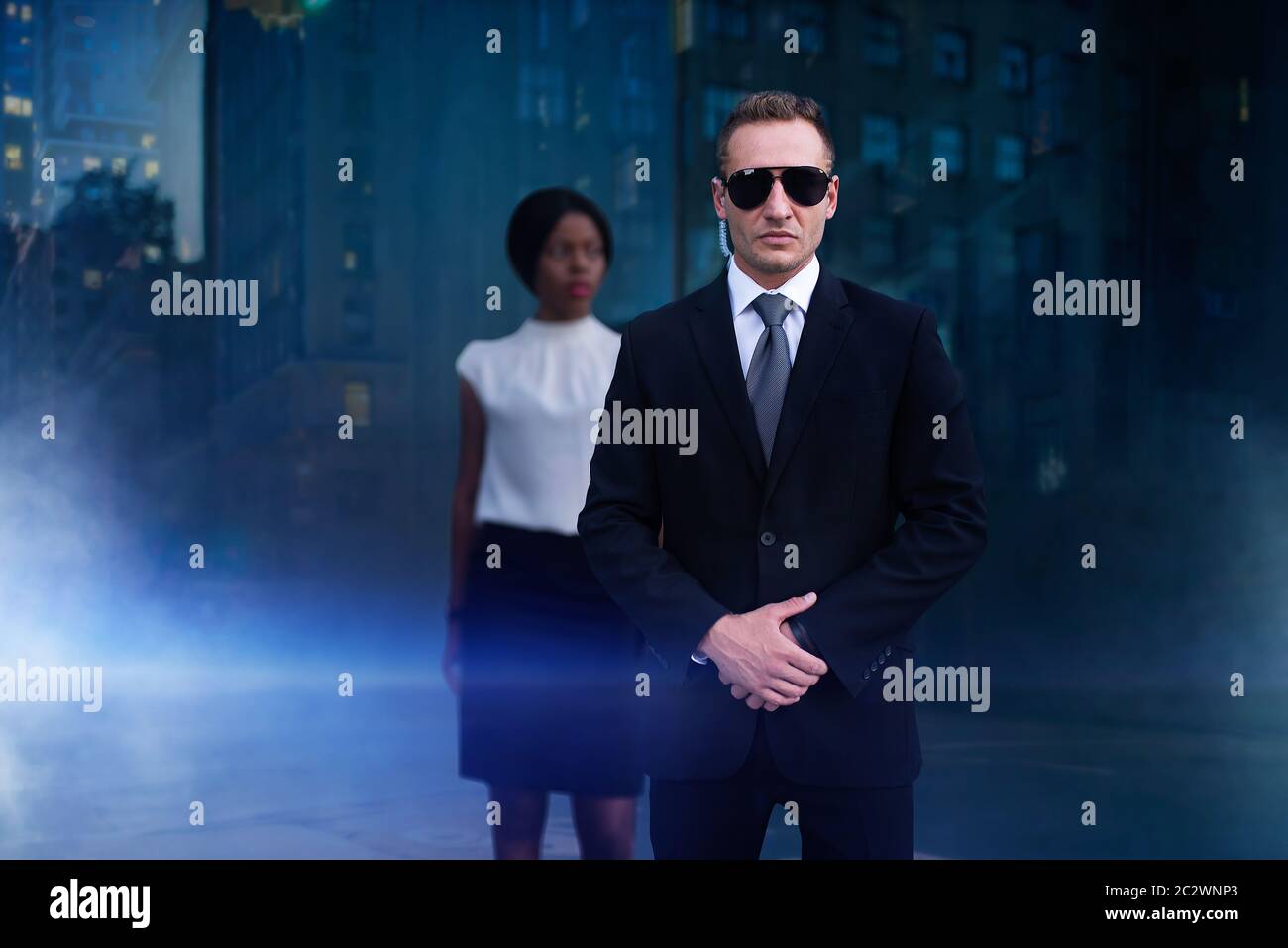 Personal bodyguard of black business woman. Security guard is a risky ...