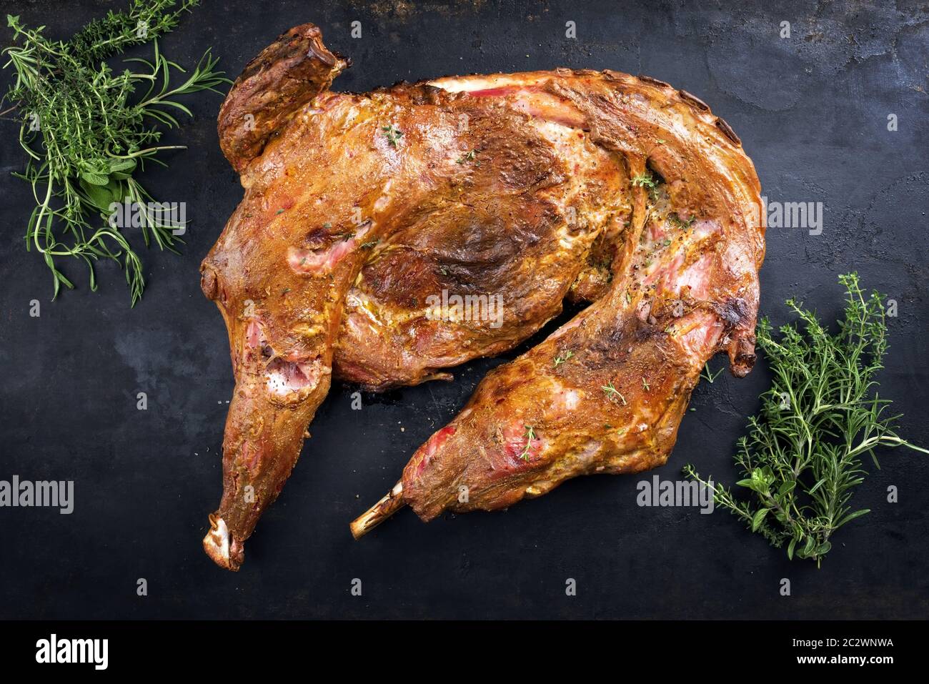 Barbecue half of dairy goat with shoulder and leg garnished with a ...