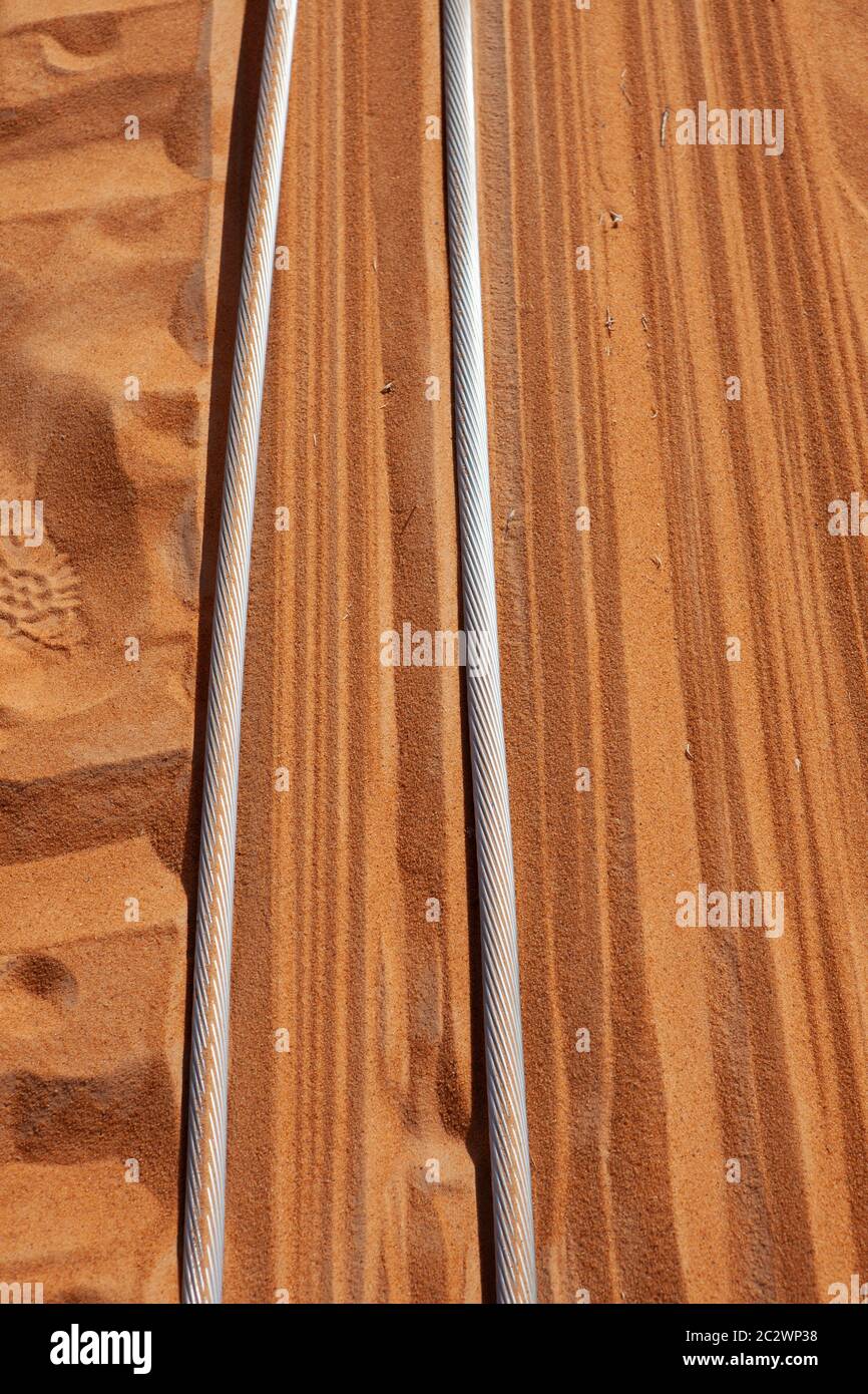 High voltage cables for electricity pylons lie in the sand waiting to ...