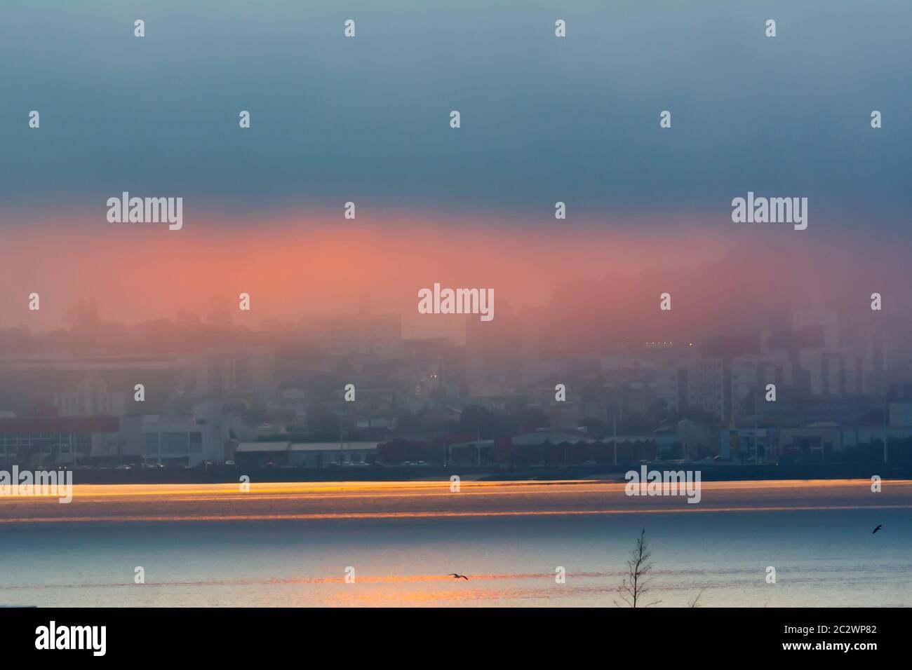 Colourful foggy sunset Stock Photo - Alamy