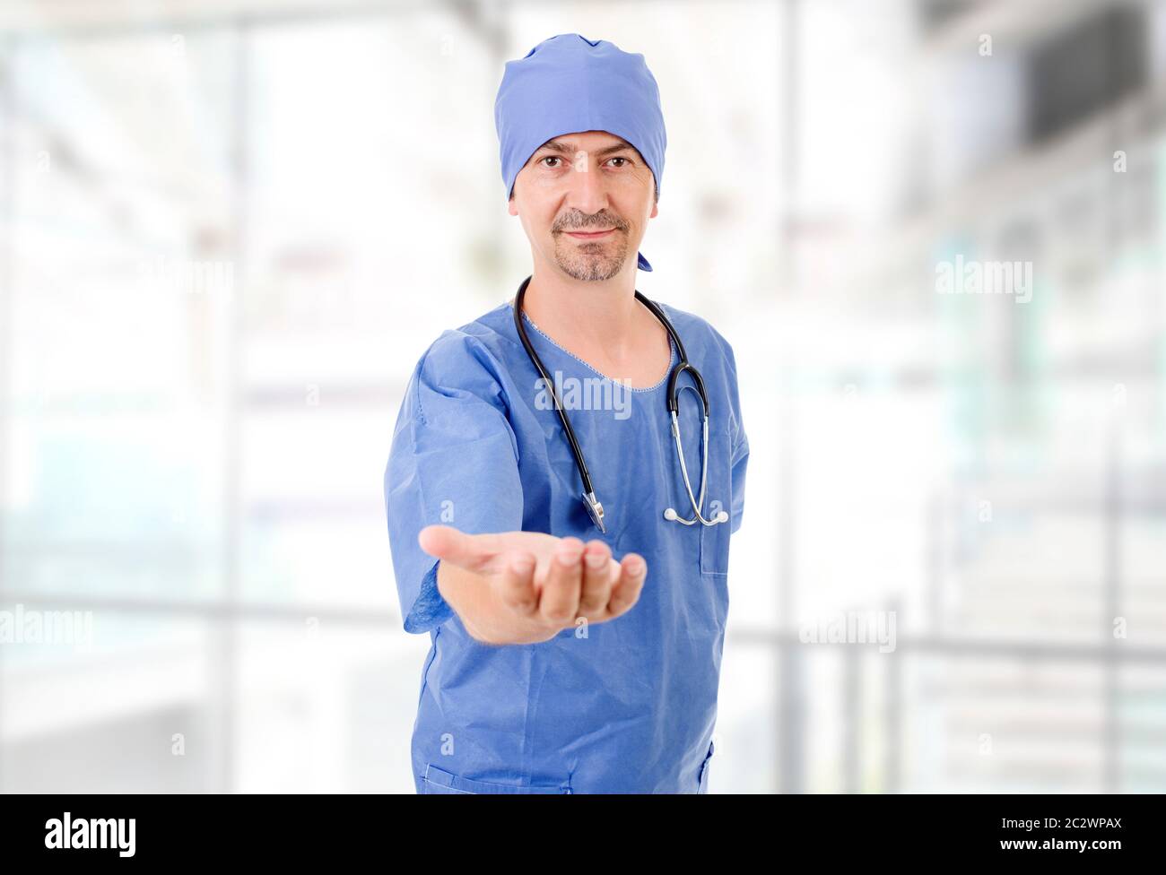 Happy male doctor offering his hand, at the hospital Stock Photo - Alamy