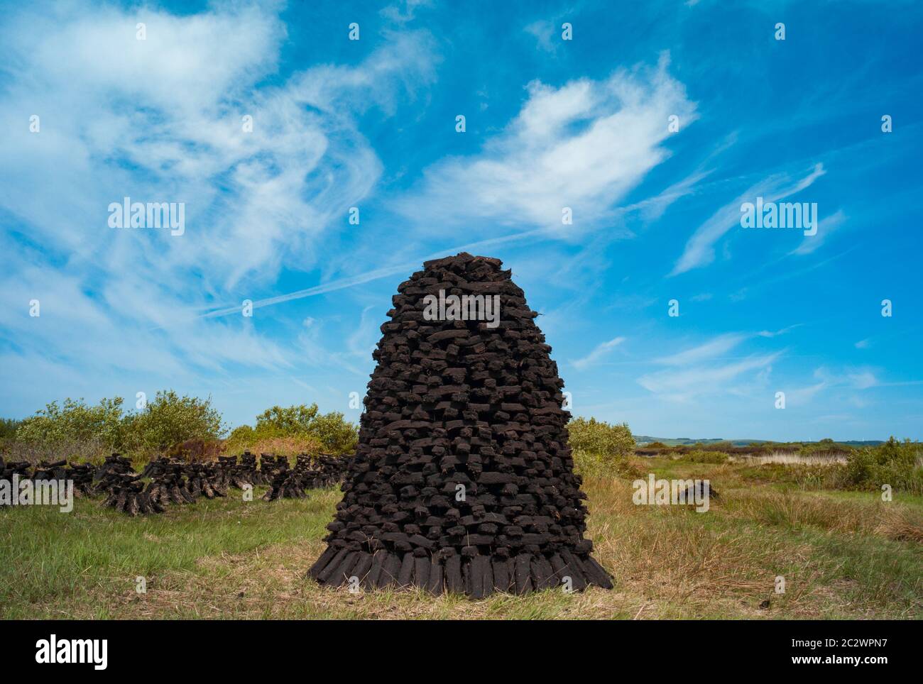 Pile of peat bog turf stacked up in field in rural county Kerry ...