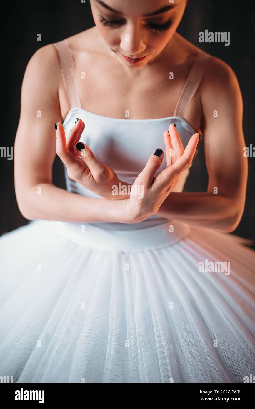 Classical ballet dancer body in white dress, black background. Slim ...