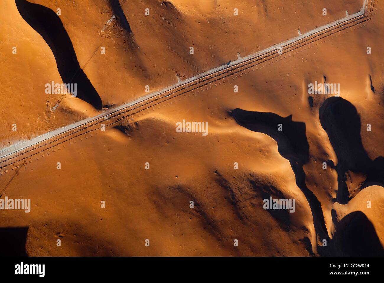 Electricity plyons being built in the Sahara desert by an oil company ...