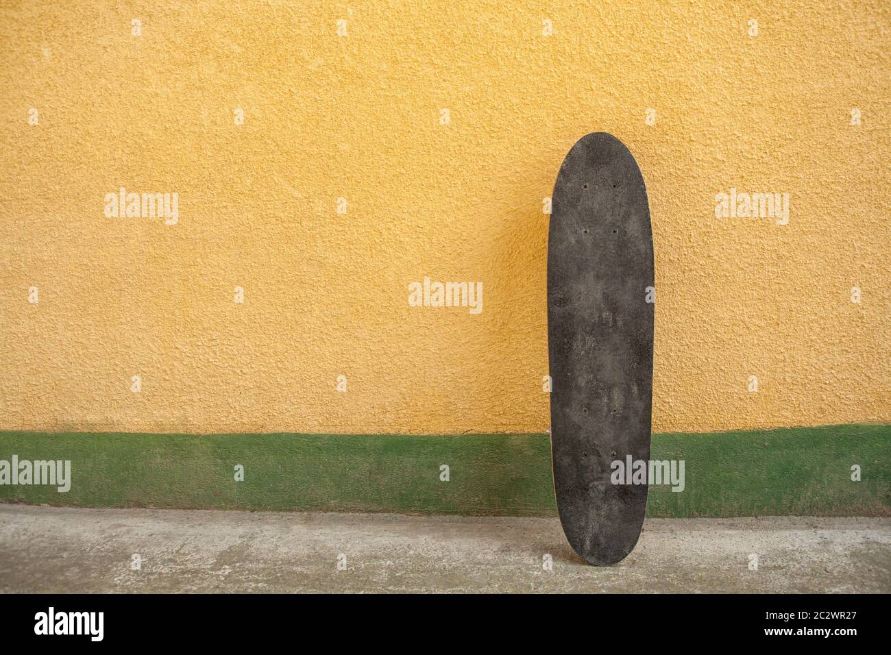 Skateboard on a wall. Used skateboard Stock Photo - Alamy