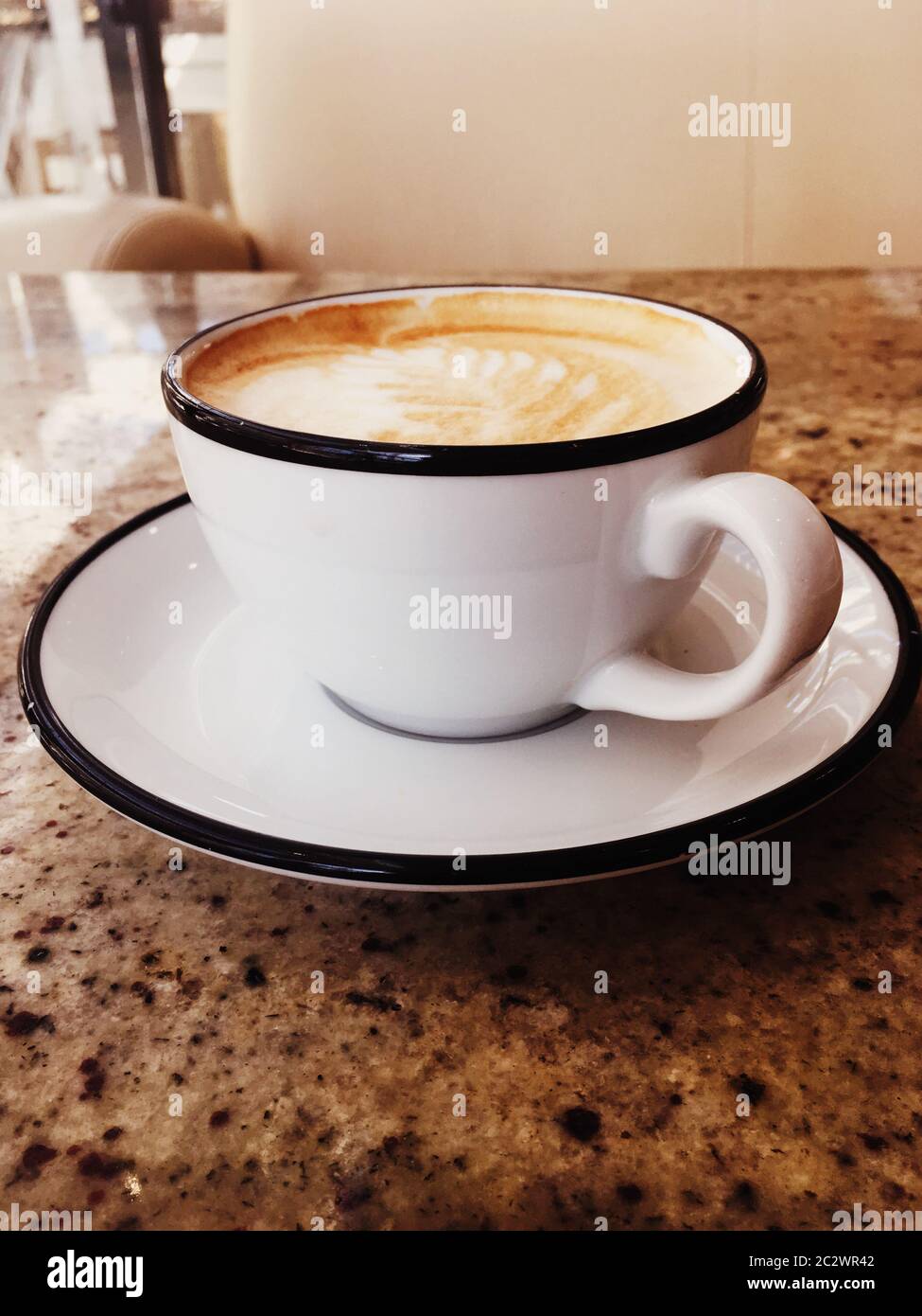 Cappuccino for breakfast in cafeteria, coffee cup on table in parisian ...