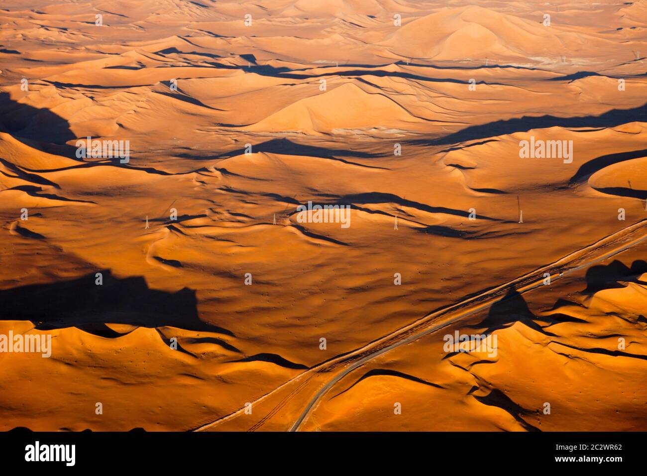 Electricity plyons being built in the Sahara desert by an oil company ...