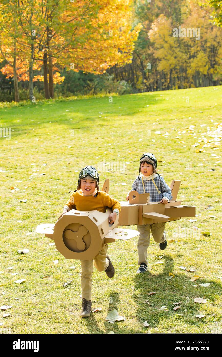 Happy boy play to fly Stock Photo - Alamy