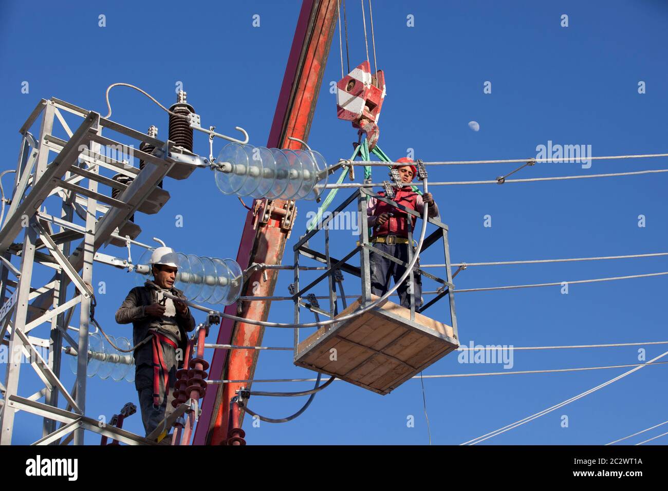 Engineers install high voltage cables at an electicity sub-station that ...