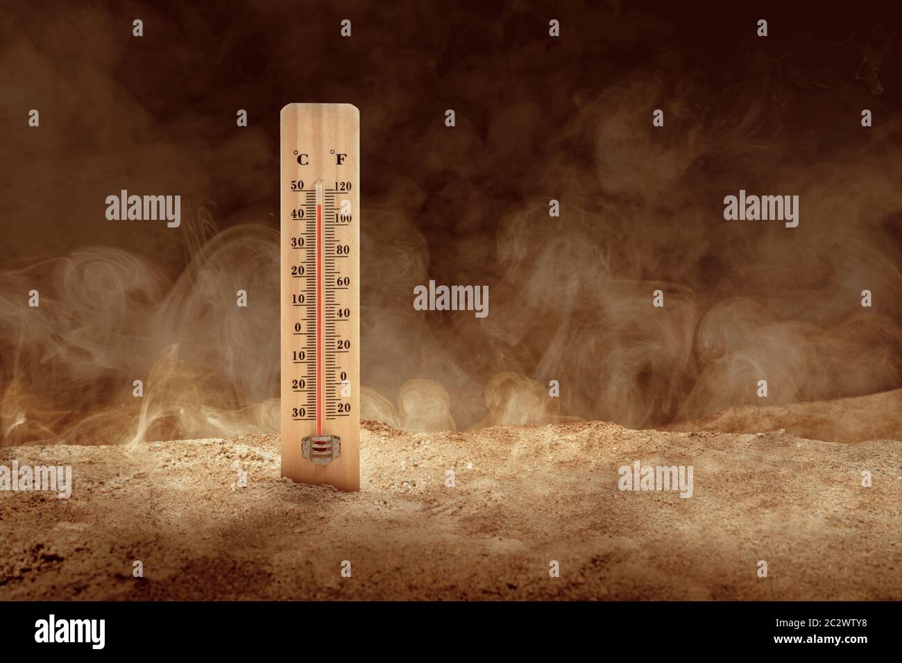 Thermometer with high temperature on the desert with a dusty background ...