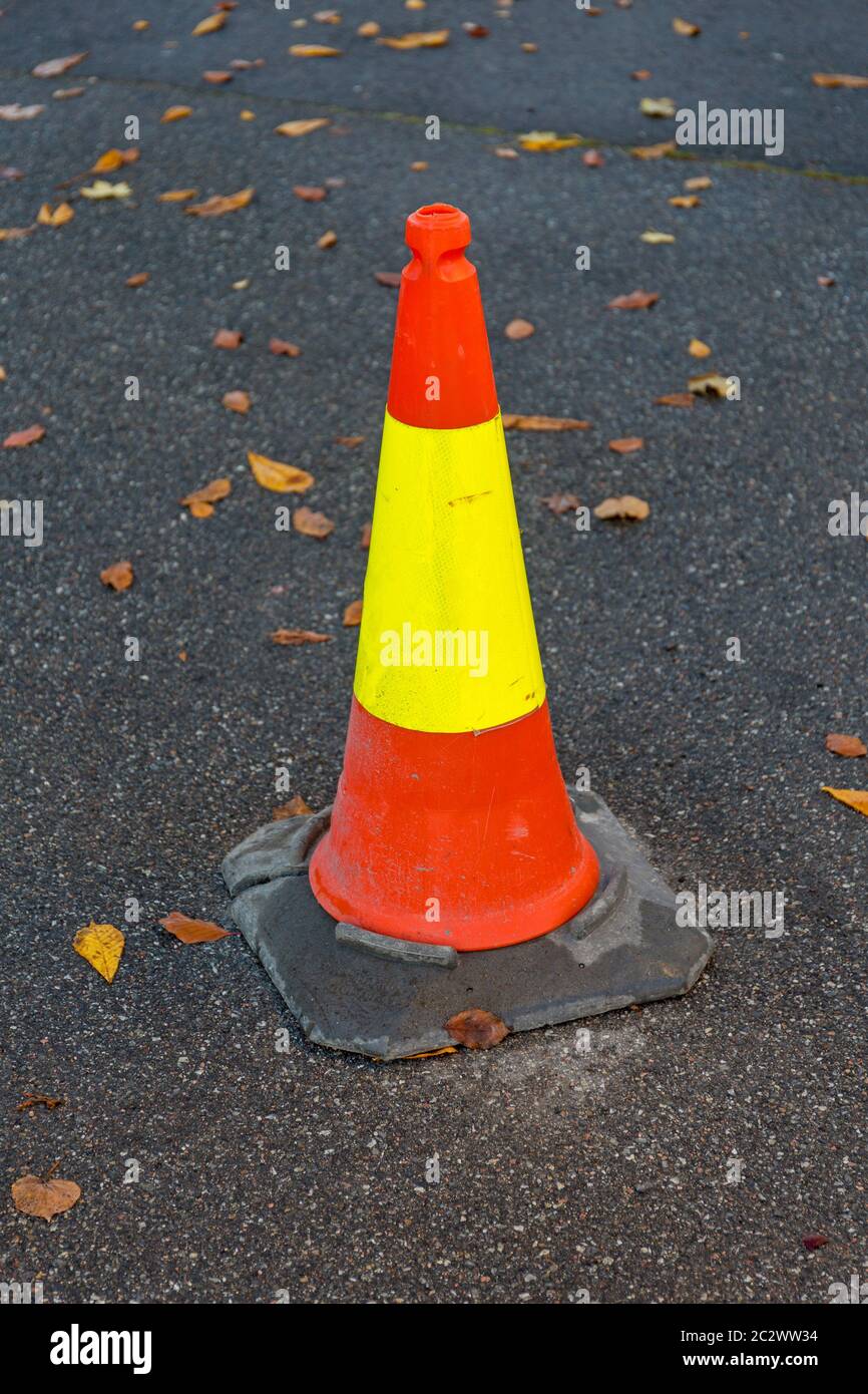 One Fluorescent Traffic Cone at Street Pavement Stock Photo - Alamy