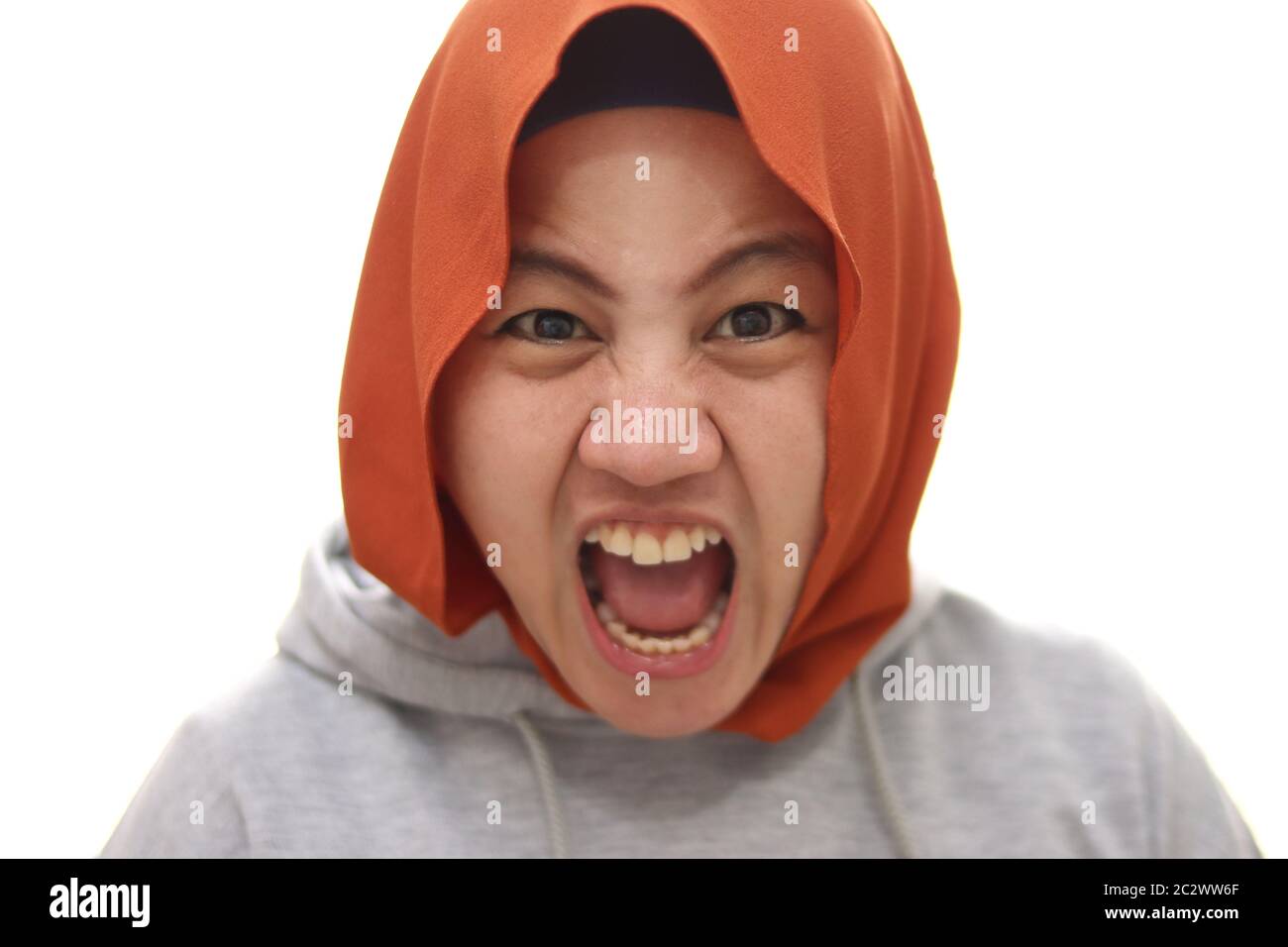 Angry muslim girl in hijab screaming loud, close up portrait against ...
