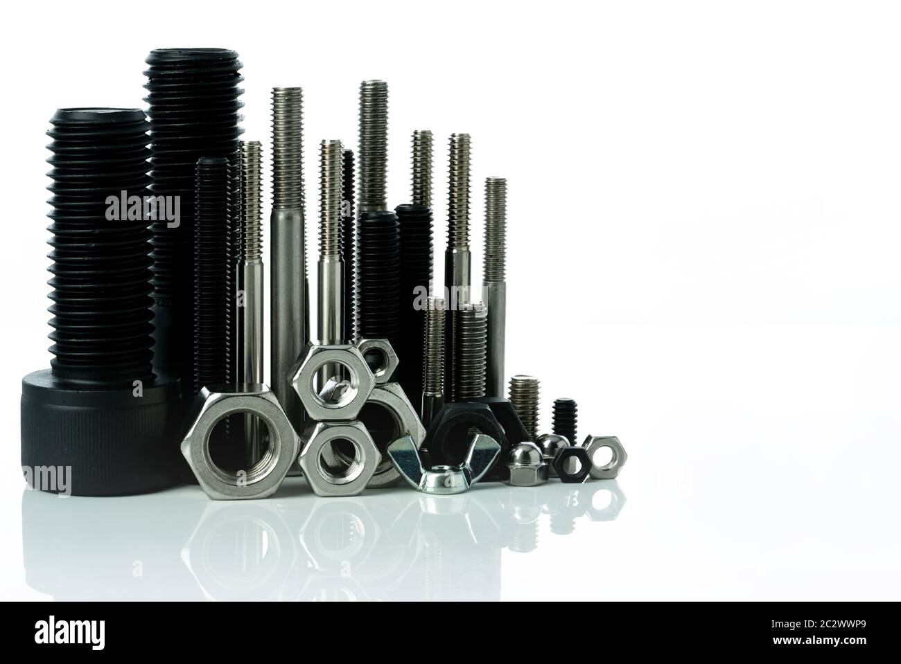 Metal bolts and nuts on white background. Fasteners equipment. Hardware tools. Stud bolt, hex ...