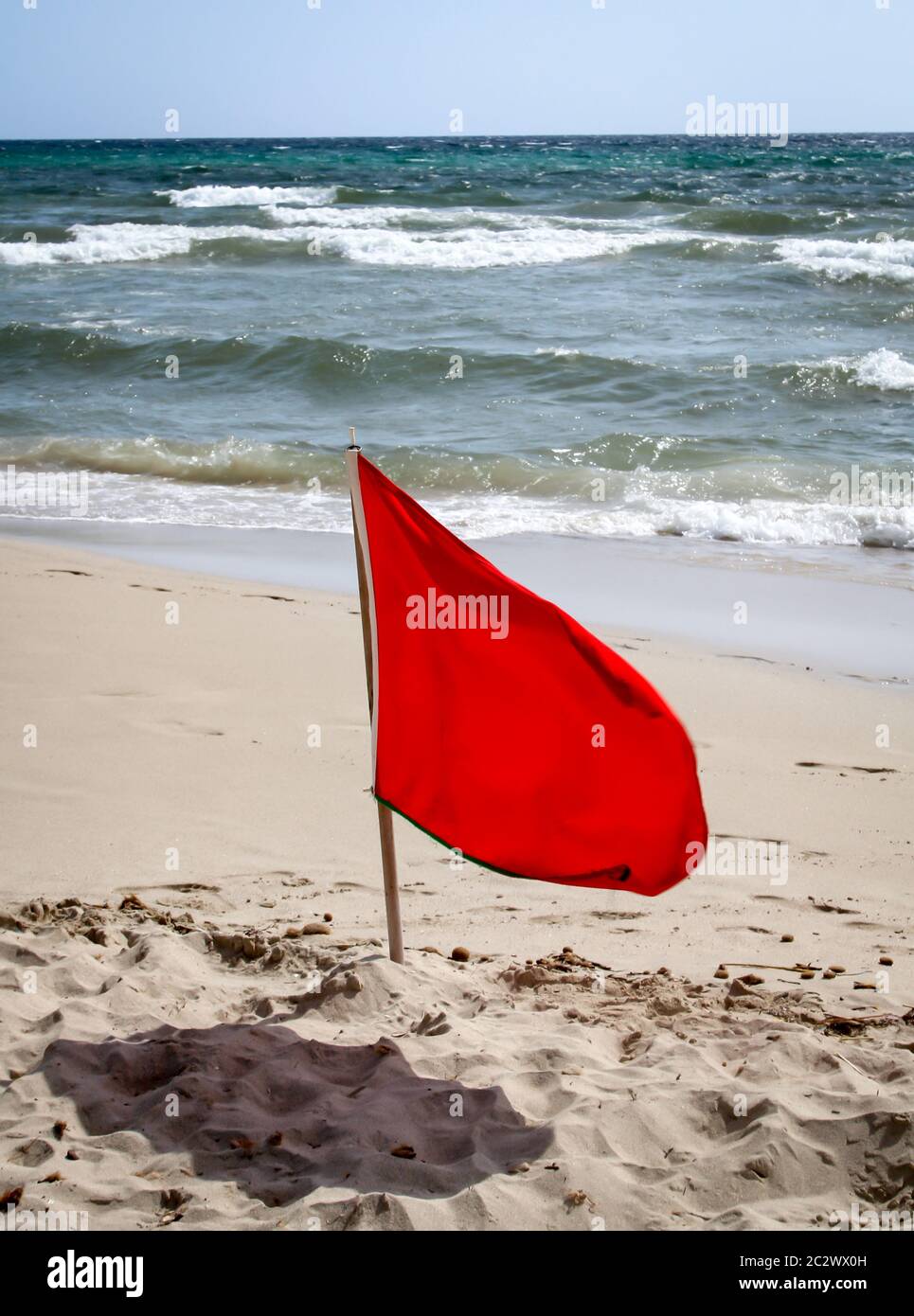 Flags on the beach indicate dangers like jellyfish, undercurrent and ...