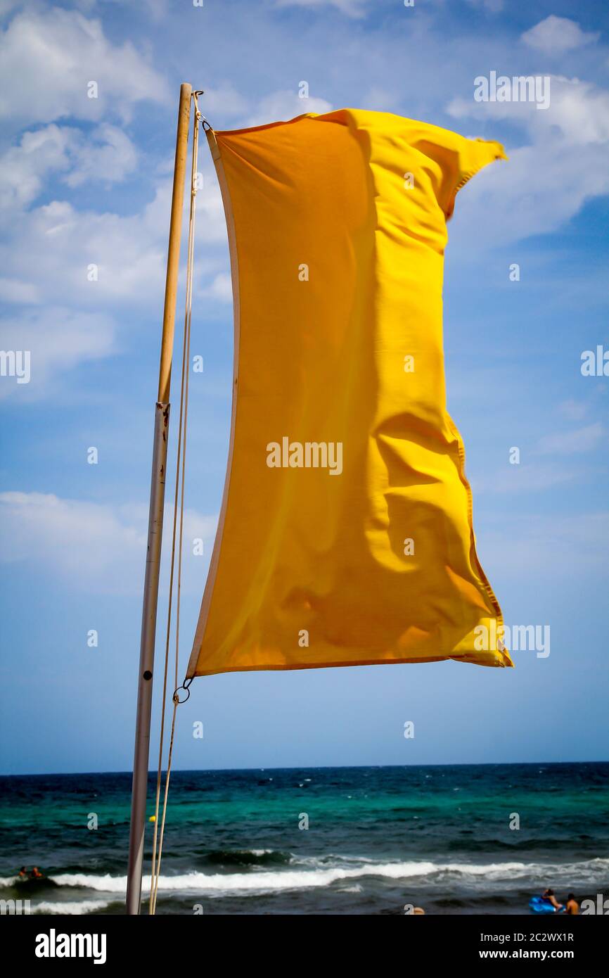 Flags on the beach indicate dangers like jellyfish, undercurrent and ...