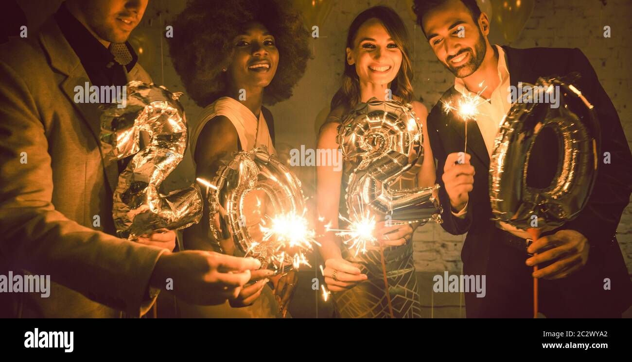 Group of party people celebrating the arrival of 2020, men and women ...