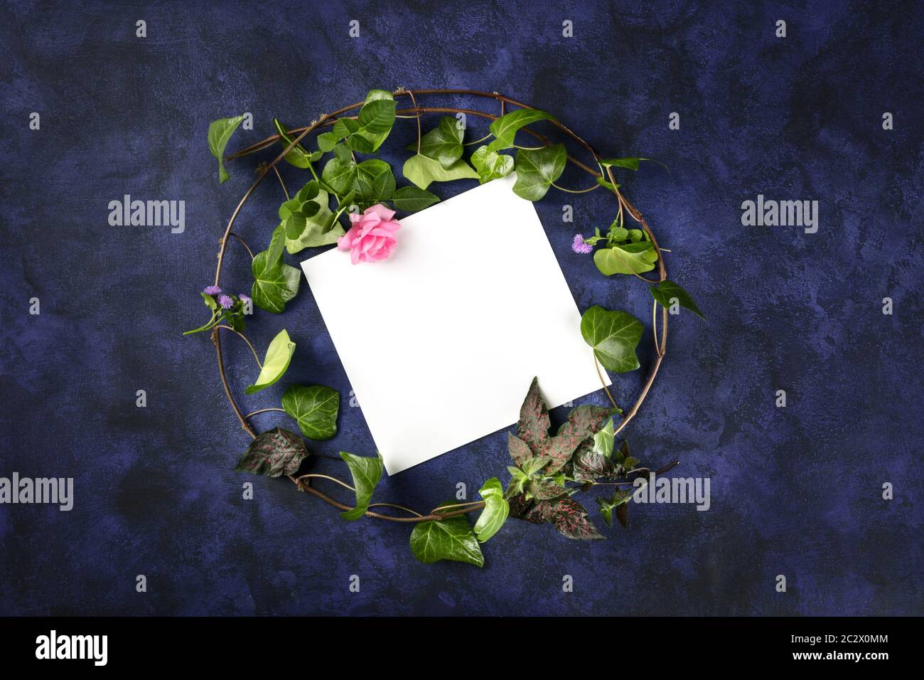 Invitation or greeting card design template with a flat lay wreath of ...