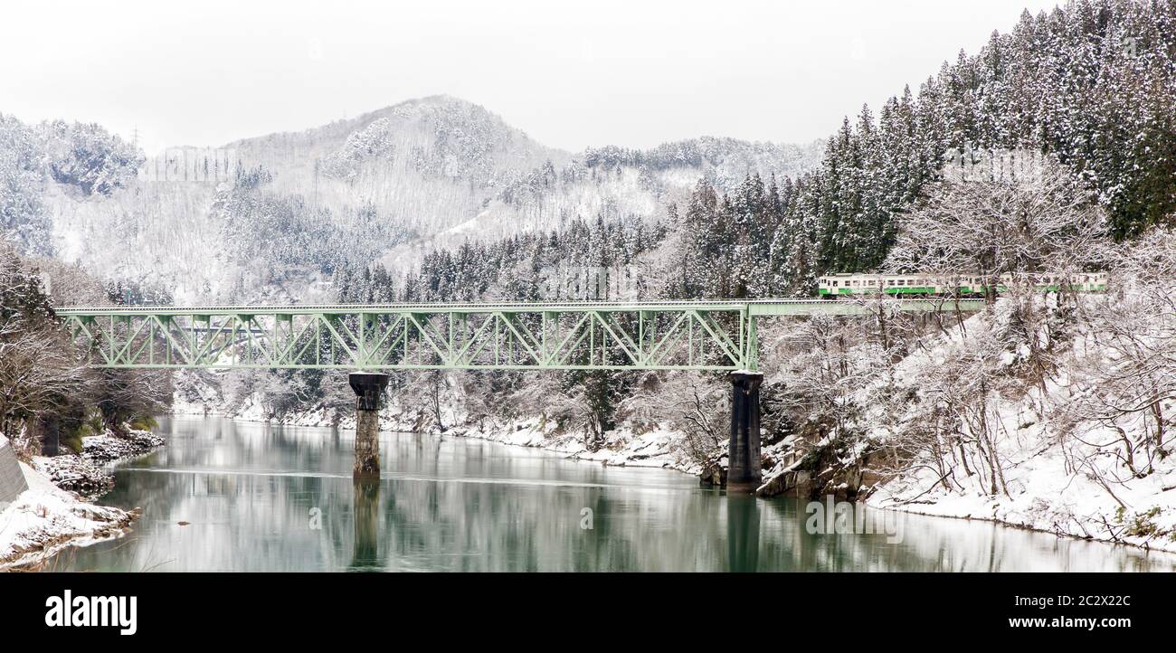 Train in Winter landscape snow on bridge Stock Photo - Alamy