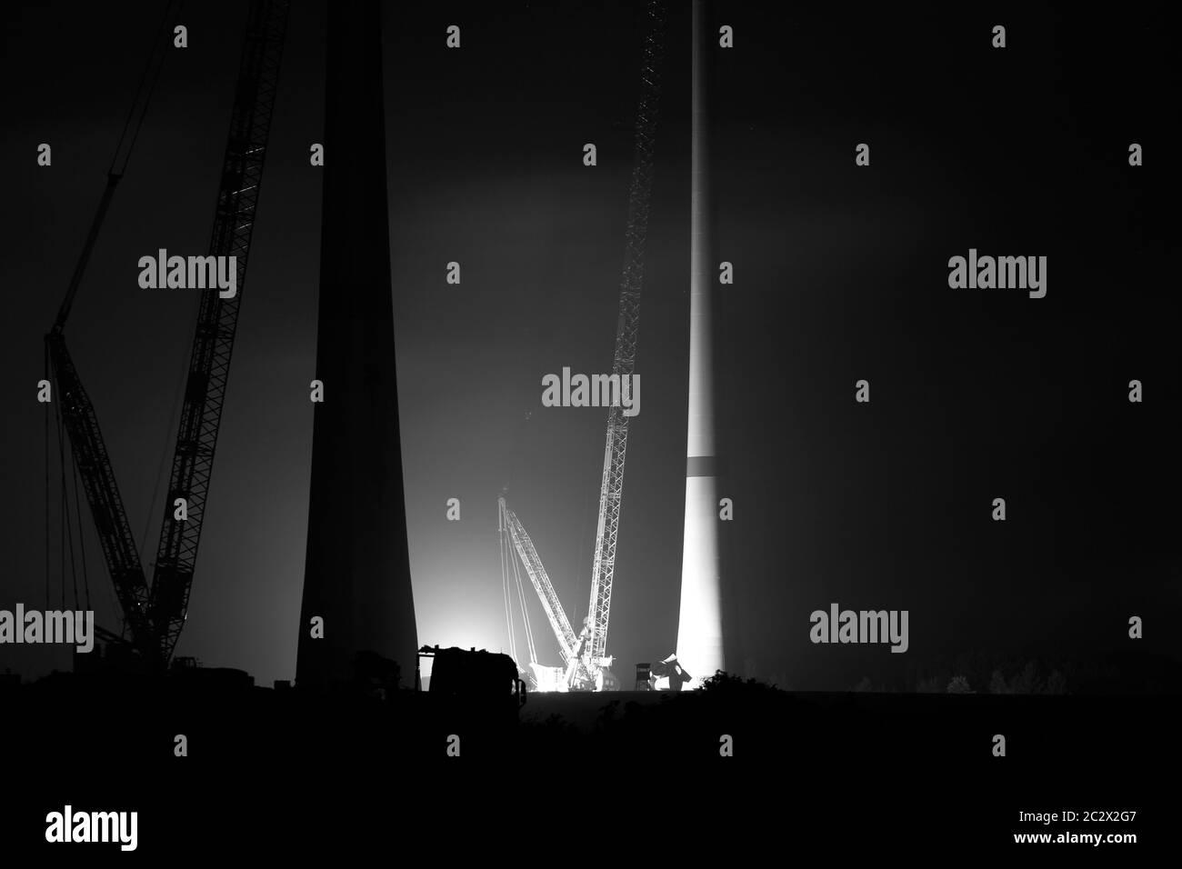wind turbine assembly, illuminated in the night Stock Photo - Alamy