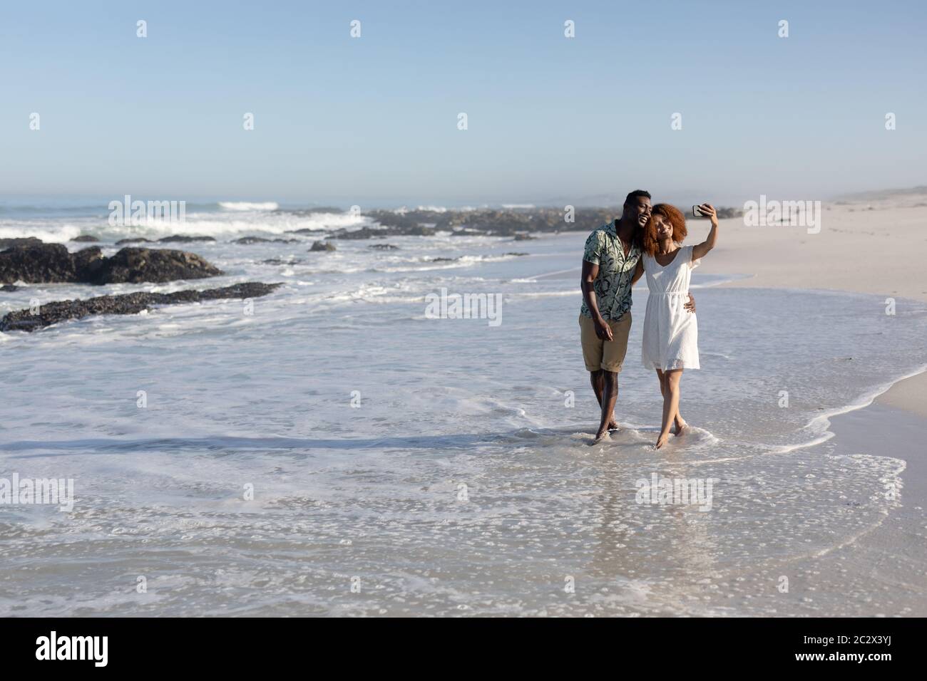 Happy couple spending time together on the beach Stock Photo - Alamy