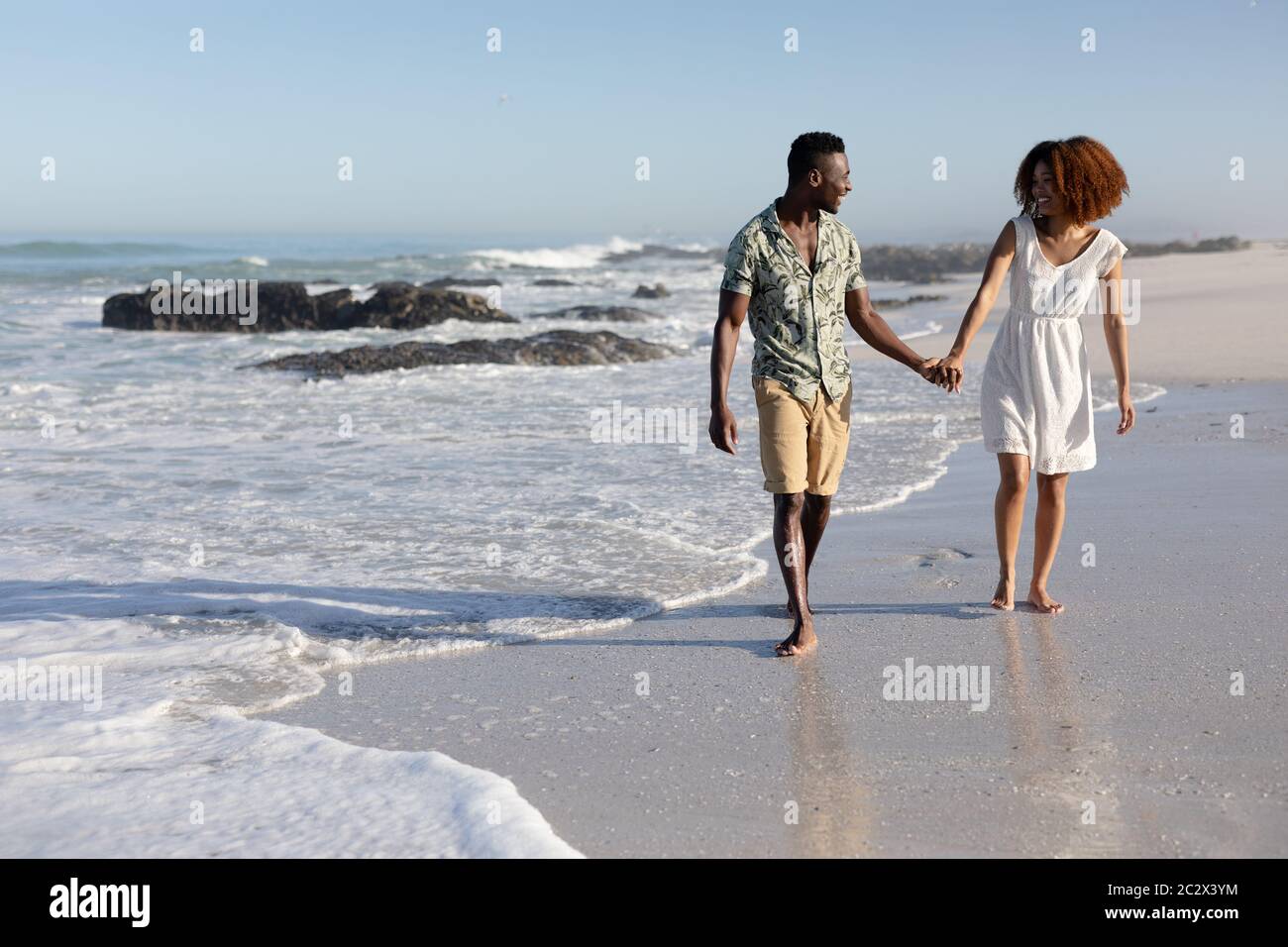 Happy couple spending time together on the beach Stock Photo - Alamy