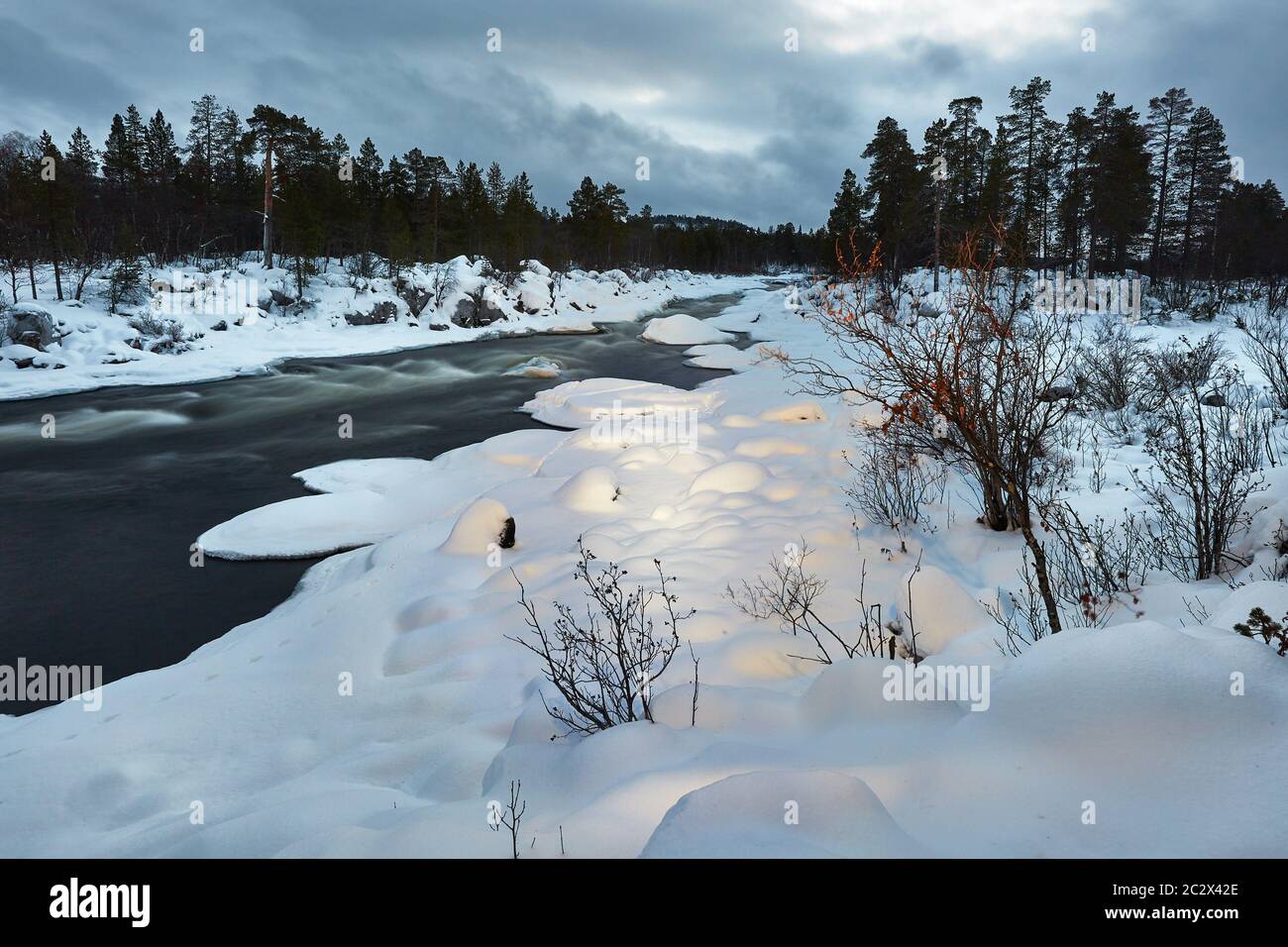 Fast river flowing in the nordic winter Stock Photo - Alamy