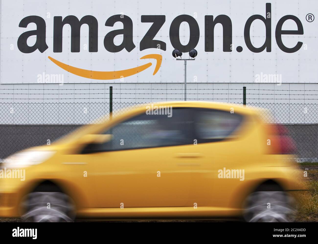 Yellow car in front of amazon logistics center hi-res stock photography ...