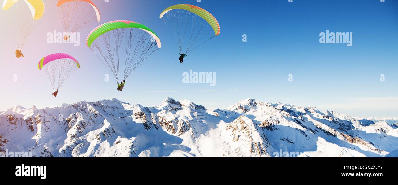 Paragliders Gliding Over The Scenic Mountains In Winter Stock Photo - Alamy