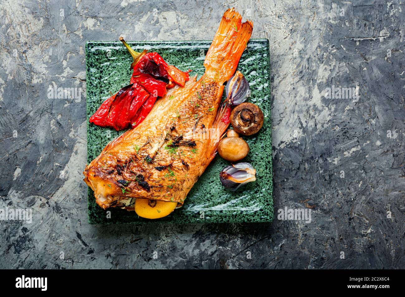 Red sea bass baked with mushrooms and red pepper.Fish with roasted ...