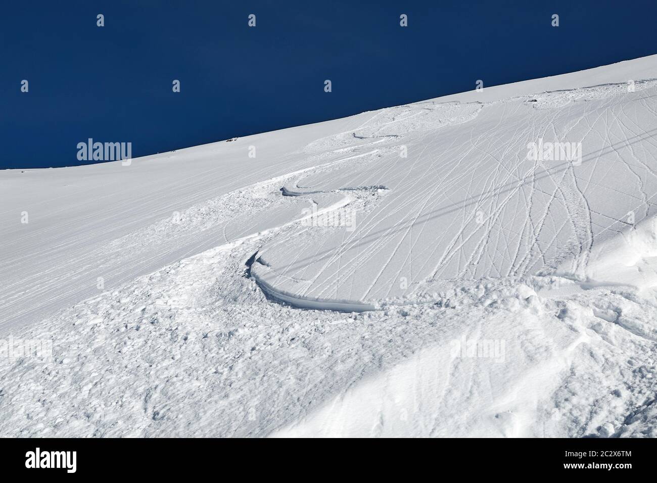 Ski and snowboard curves in the fresh snow slope Stock Photo - Alamy