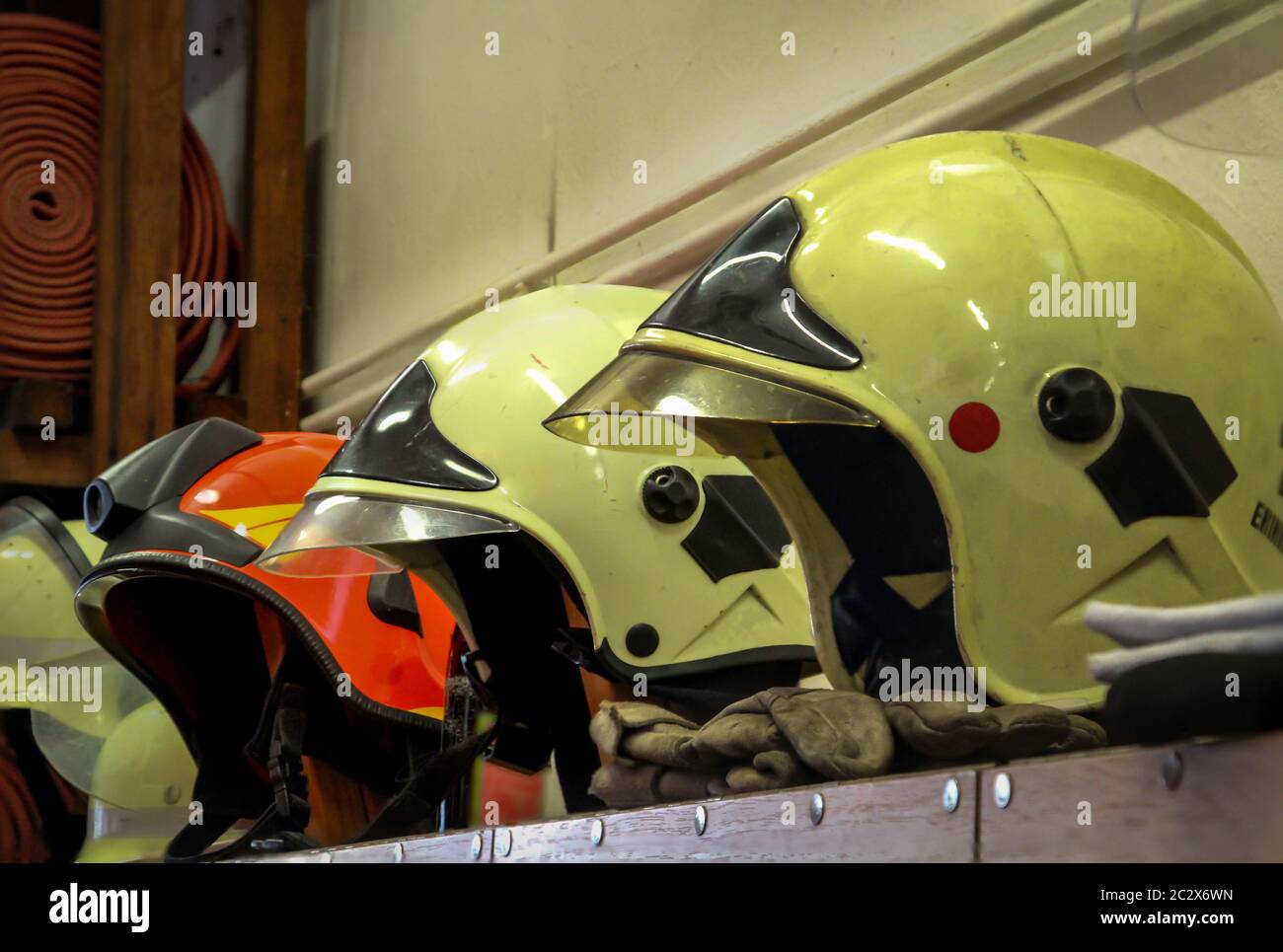 Helmets of firefighters, fire helmet are at hand parked Stock Photo - Alamy