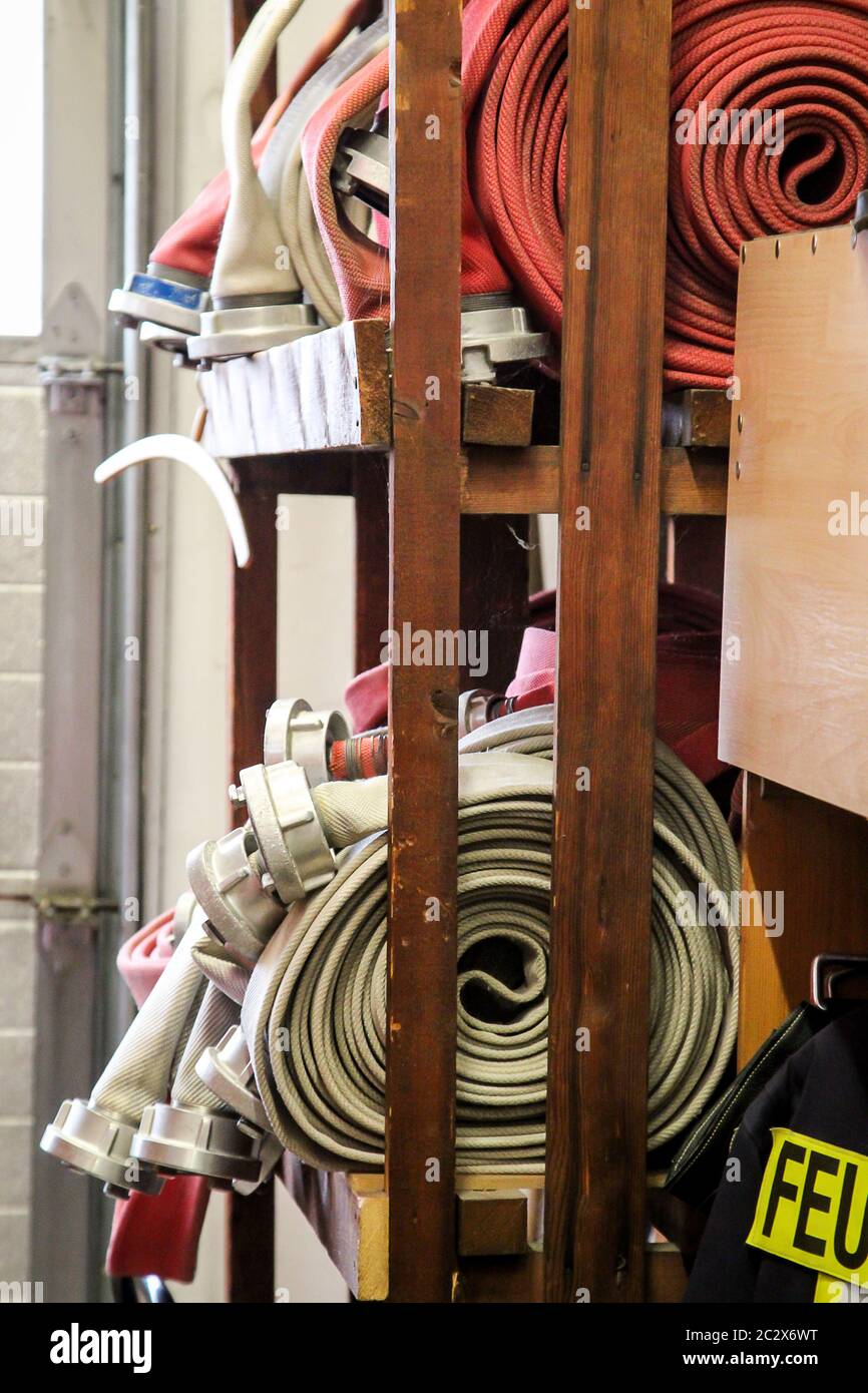 Fire department hoses stacked on a shelf for use Stock Photo - Alamy