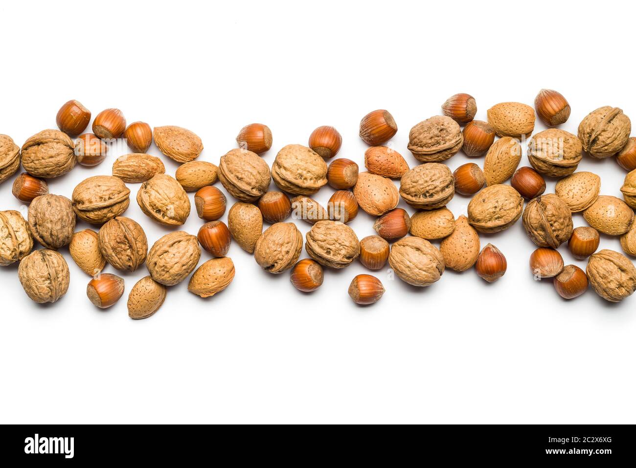 top view of mix of nuts scattered on white background with copy space ...