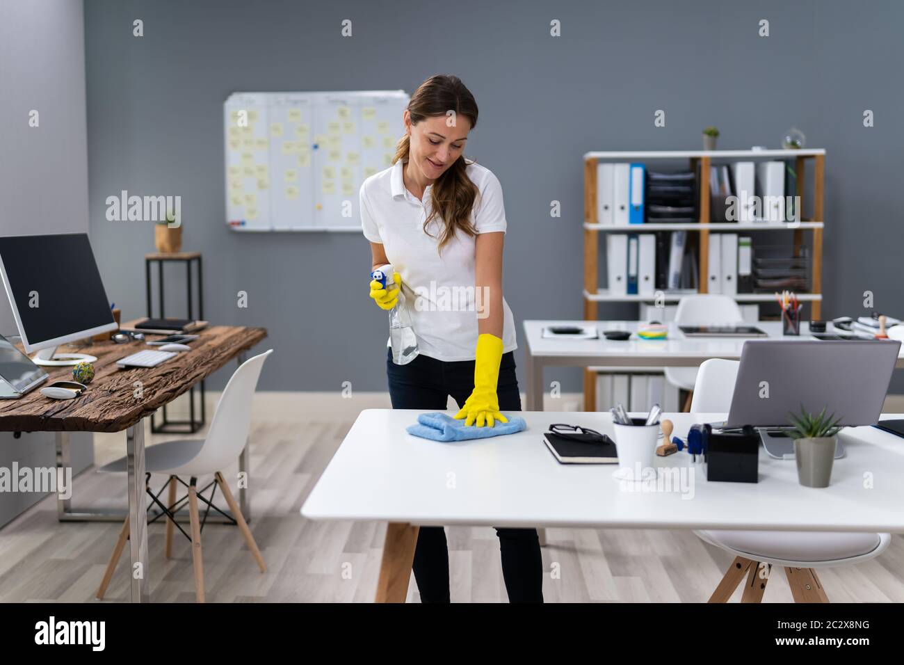 Female cleaner wiping office desk hi-res stock photography and images ...