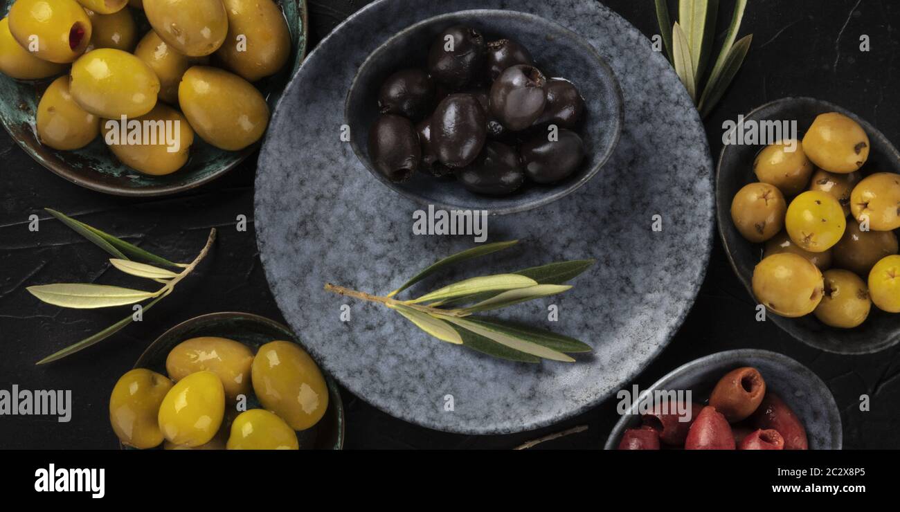 Olives flat lay panoramic overhead shot. Black, green and red olives on ...