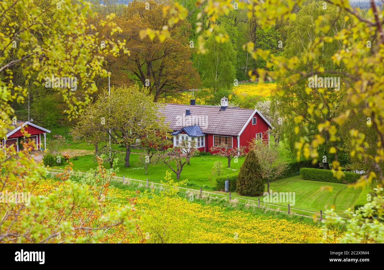 Red country house in a beautiful landscape Stock Photo - Alamy