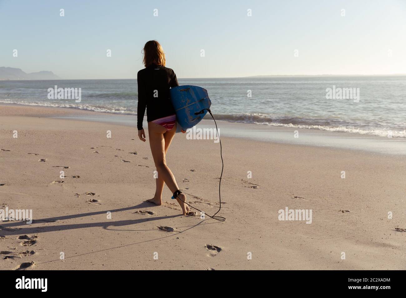 Caucasian woman during surf session at beach Stock Photo - Alamy