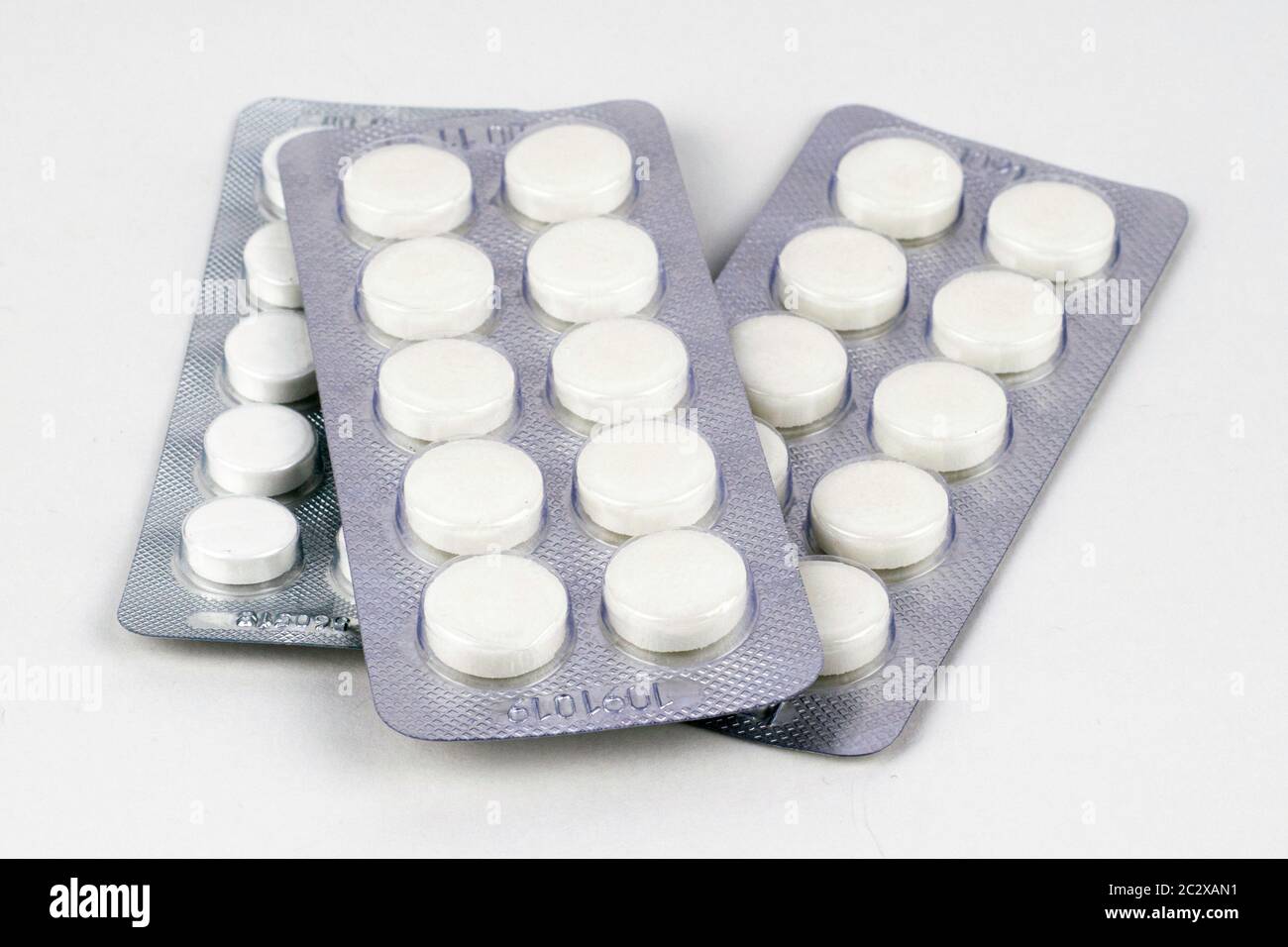 three packs of white tablets in blisters on a white background Stock ...