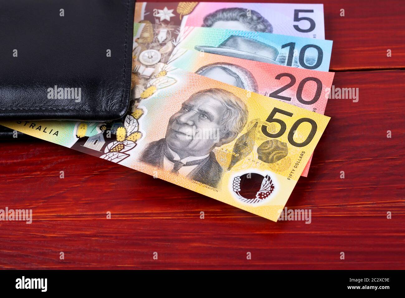 New series of Australian dollars in the black wallet Stock Photo - Alamy