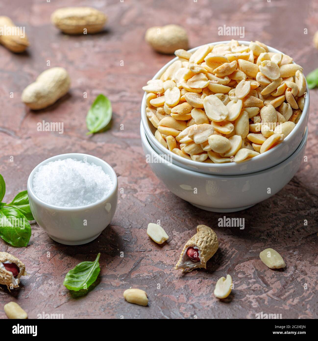 Fried salted peanuts in a white bowl Stock Photo - Alamy
