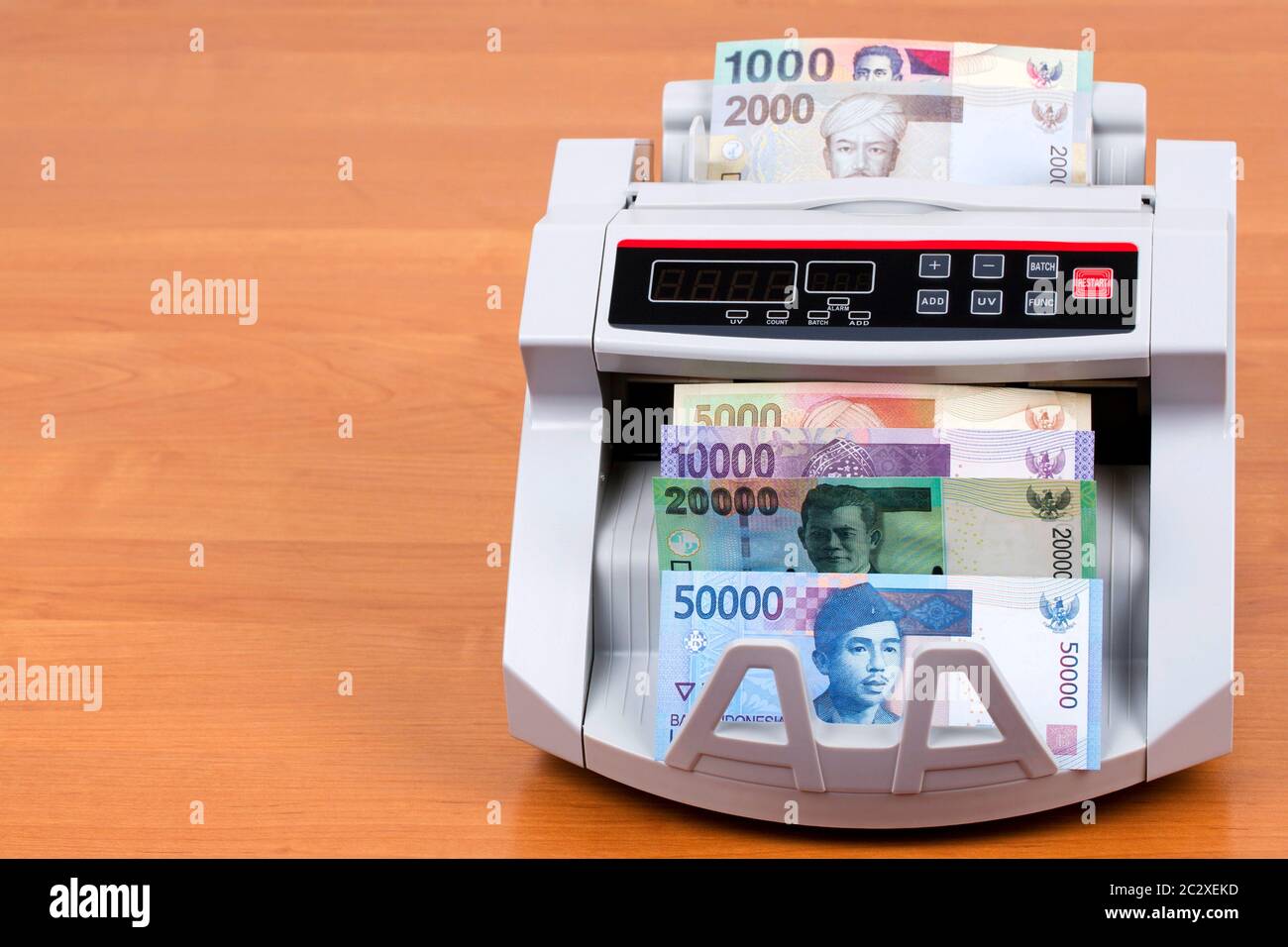 Old money from Indonesia in a counting machine Stock Photo - Alamy