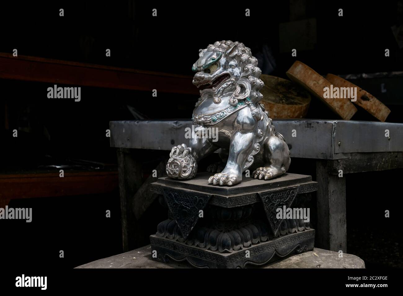 Silver statue of a Chinese lion type mythical beast Thailand S. E. Asia ...