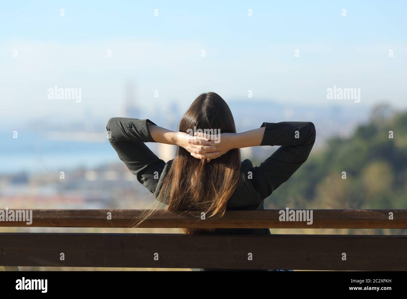 Back view portrait of a businesswoman relaxing resting sitting on a ...